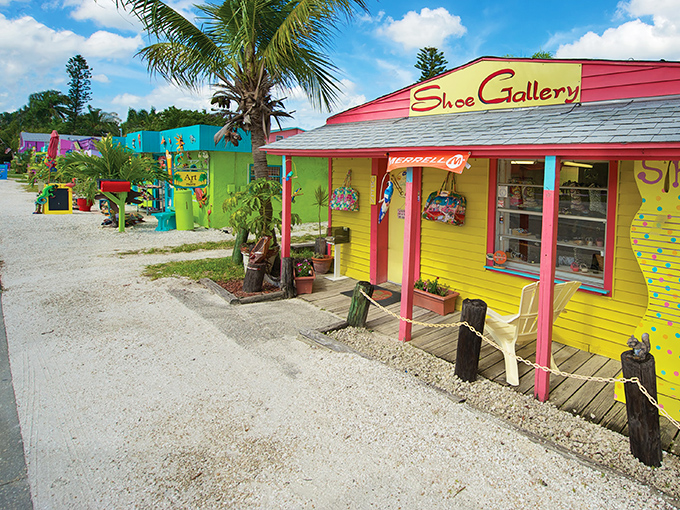 The vibrant storefronts of Matlacha create an artist's palette along the roadside, where even a shoe store becomes a masterpiece in yellow and pink.