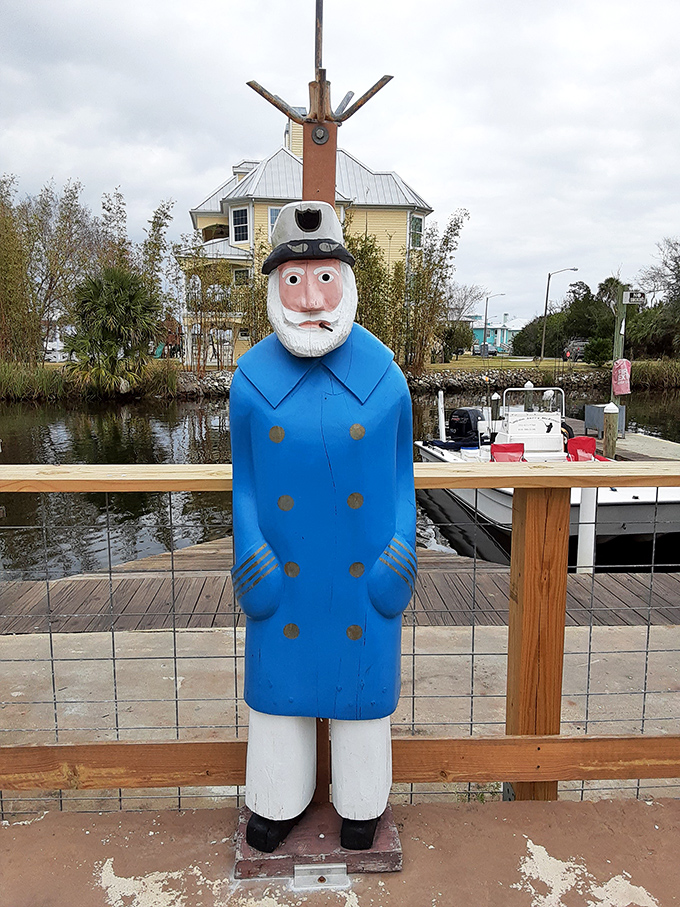 A whimsical sailor statue stands guard by the water, a quirky touch that perfectly captures the restaurant's playful spirit and maritime heritage.