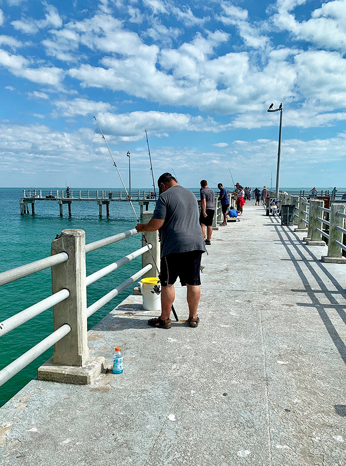Fishing: Anglers line the concrete pier, their patience and optimism as steady as the waves lapping beneath their dangling lines.