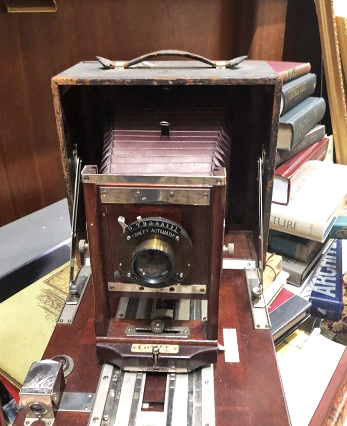 Capturing moments from another era, this folding camera represents the technological marvels that documented the world these books describe.