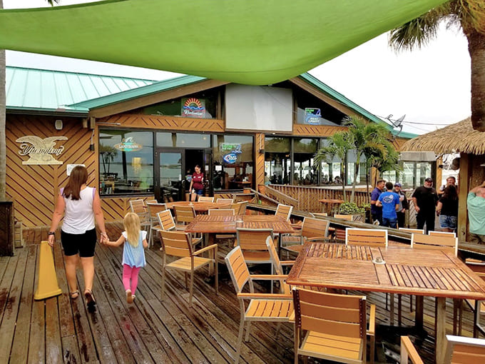 Outdoor dining space where palm trees sway and every meal comes with complimentary ocean breezes included.