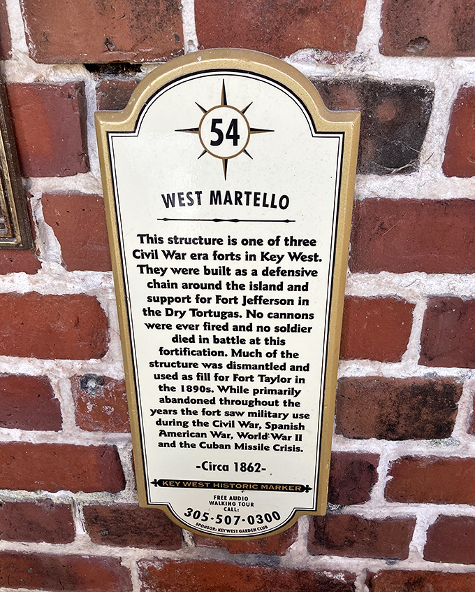 History preserved in brick and mortar &ndash; this marker reveals West Martello's military past before its botanical transformation.