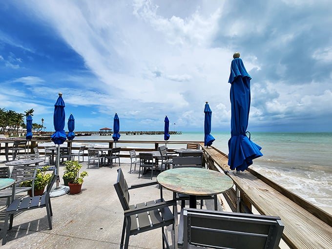 Ocean views that make you forget what day it is. Those blue umbrellas aren't just shade&mdash;they're exclamation points on a perfect afternoon.