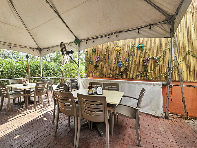 Under bamboo and canvas, the patio creates an outdoor dining room where island breezes deliver appetizing aromas from nearby tables.