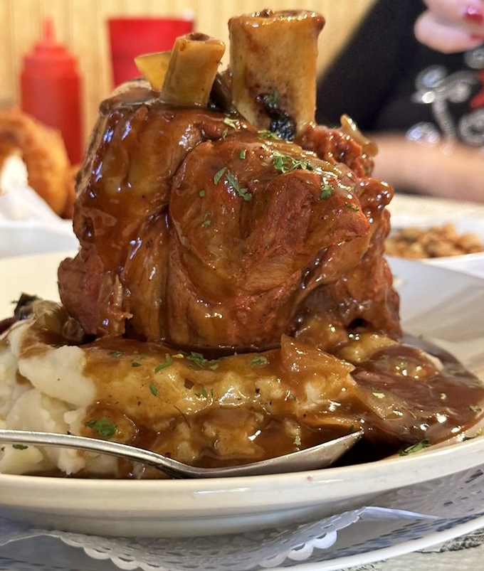 Fred Flintstone would approve of this prehistoric-sized portion, glistening with savory gravy atop a mountain of buttery mashed potatoes.