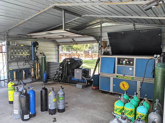 The technical heart of diving operations, where tanks are filled and equipment checked with the precision that underwater safety demands.