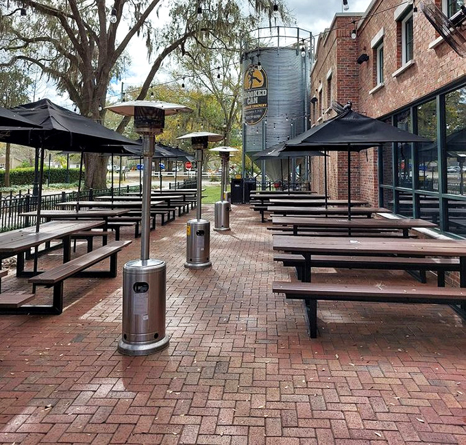 The outdoor seating area offers a peaceful retreat under the watchful gaze of Florida's majestic oak trees.