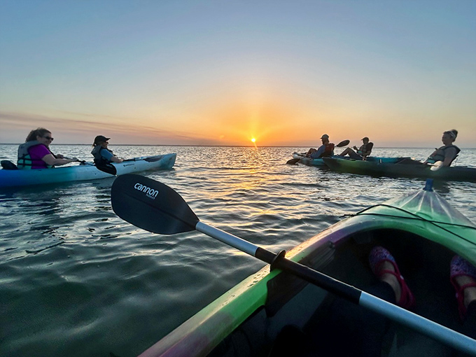 Friends gather on glassy waters to witness day's end, creating memories that will outlast the setting sun.