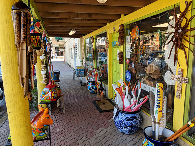 The Village Beach House corridor bursts with coastal-inspired treasures and artwork, proving Florida kitsch can actually be stylish when curated with care.