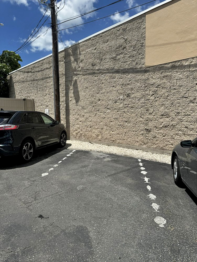 Follow the footprints to seafood paradise! Walt's parking lot path is like the yellow brick road, but leads to grouper instead of wizards.