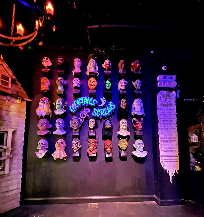 A wall of horror masks showcases the bar's dedication to celebrating the genre year-round, creating a gallery of iconic frightening faces.