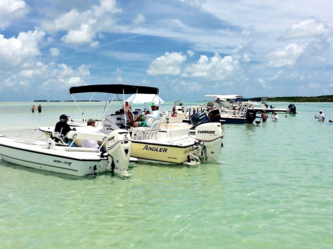 Boats gather in waters so clear they appear suspended in air, like a magic trick Mother Nature performs daily.