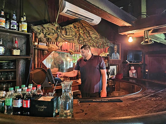 Staff: Behind the storied bar, today's keeper of Cap's liquid traditions tends to his domain, continuing practices established when rum-running was the family business.