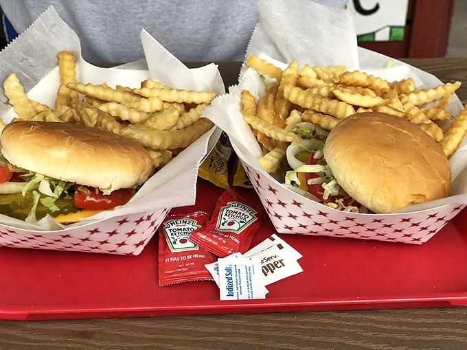 Two perfect cheeseburgers with golden fries &ndash; a reminder that sometimes the simplest pleasures are still the most satisfying.