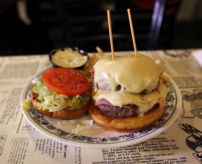 A towering achievement in burger architecture, where melted cheese cascades down twin patties like a delicious golden waterfall.