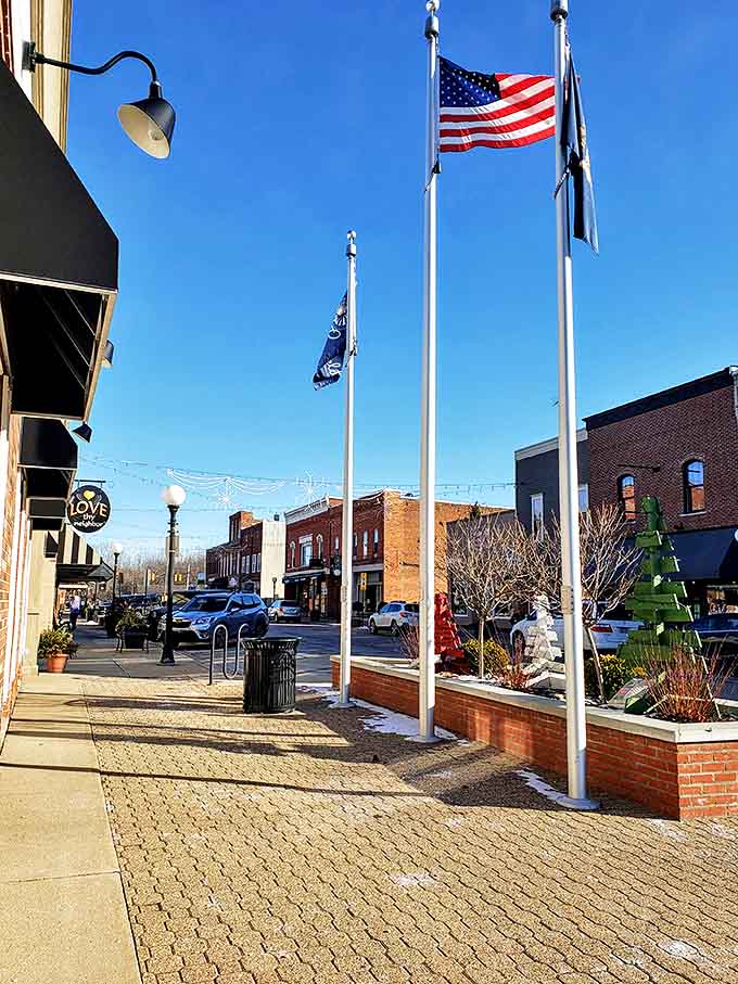 Downtown storefronts fly their flags proudly, each building contributing to a streetscape that actually looks like somewhere instead of anywhere.