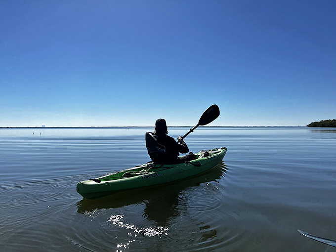 Solo paddling offers meditative moments on mirror-like waters, where sky and sea become indistinguishable.