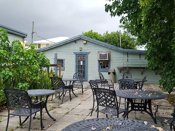 Outdoor seating: Empty tables wait patiently on the patio, ready for diners seeking salt-kissed breezes with their meals in this little corner of old Florida.