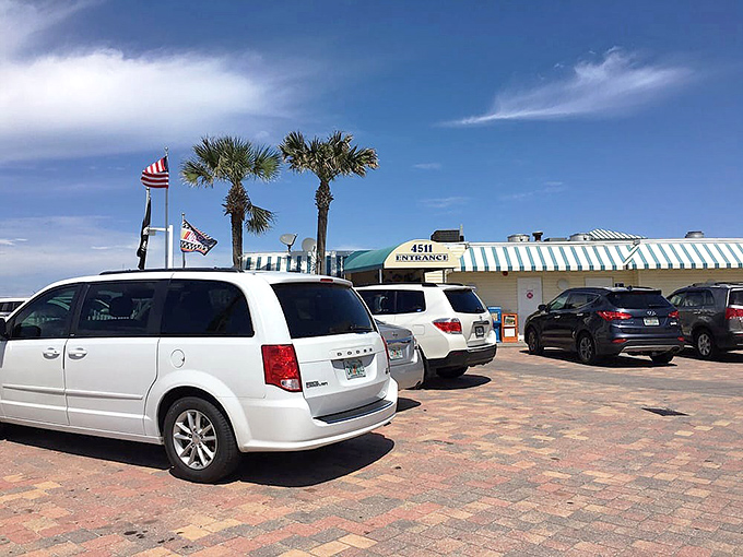 The restaurant's exterior welcomes hungry visitors with palm trees and plenty of parking&mdash;the starting line for your culinary racing adventure.