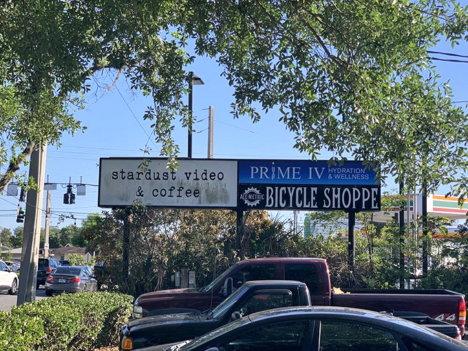 The unassuming storefront sign promises exactly what awaits inside: videos, coffee, and an experience unlike anything else in Orlando.