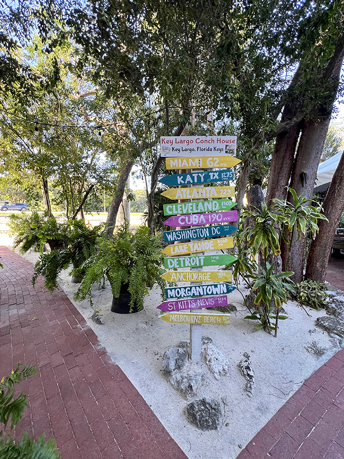 A whimsical signpost reminds diners how far they've traveled from ordinary &ndash; pointing to distant cities while anchored firmly in Keys paradise.