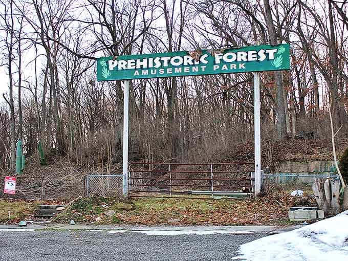 The faded entrance sign stands as a poignant reminder of Prehistoric Forest's former glory days.
