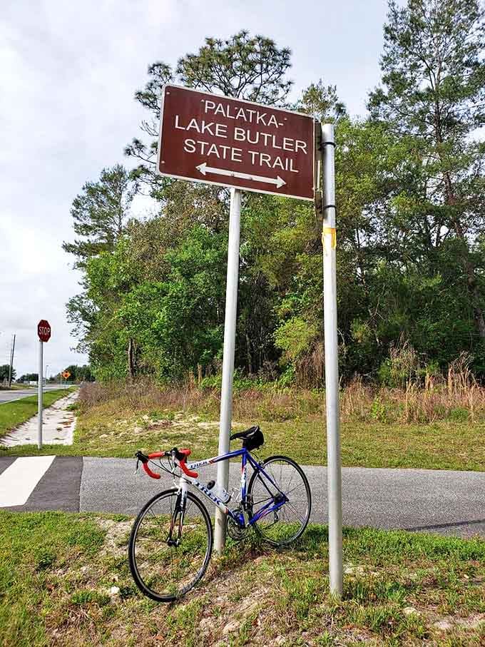 The Palatka-Lake Butler State Trail sign marks the gateway to adventure, standing proud like a welcome mat for anyone ready to discover Florida's quieter side.