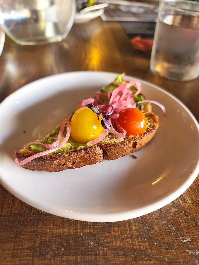 Avocado toast gets a colorful upgrade with vibrant heirloom tomatoes and pickled red onions &ndash; proof that simple ingredients can create extraordinary flavors.