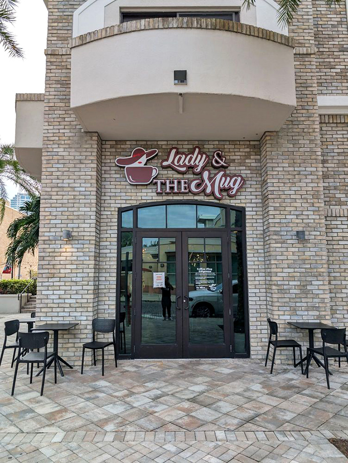 Palm trees frame the outdoor seating area, where the Florida breeze carries the scent of coffee to passersby &ndash; nature's most effective advertising.