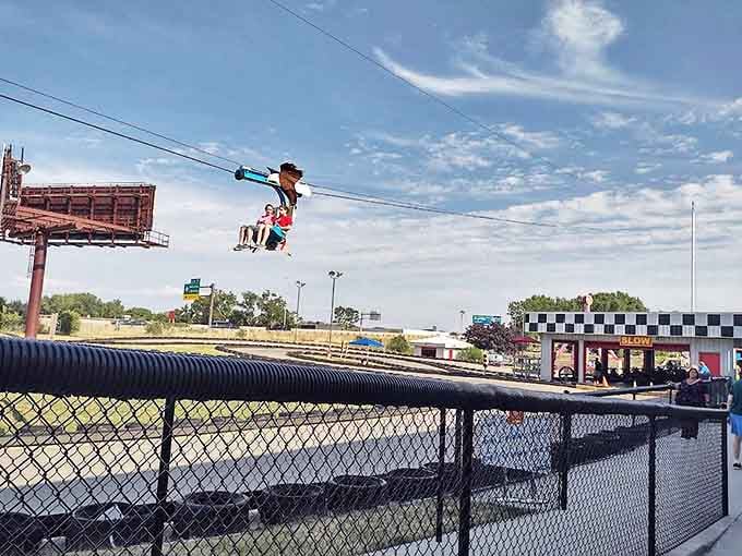 Zipline: Momentary superheroes soar above the complex, experiencing the unique thrill of controlled falling while spectators gaze upward in envy.
