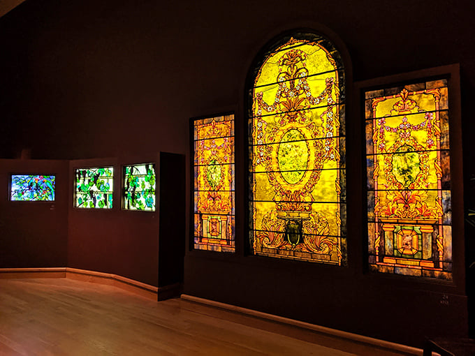 Magnificent Tiffany stained glass windows glow with jewel-like colors, showcasing the artist's mastery of light and glass.