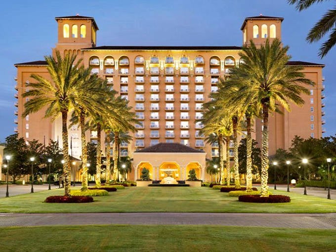 The Ritz-Carlton Orlando's grand entrance says "vacation royalty" before you've even handed over your car keys. Palm trees standing at attention like nature's doormen.
