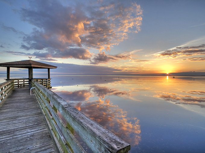 Lake Eustis welcomes visitors with Spanish moss-draped cypress trees creating a magical shoreline that seems to whisper old Florida tales.