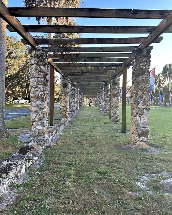 Stone columns stand like ancient sentinels along this historic walkway, whispering tales of Depression-era craftsmanship.