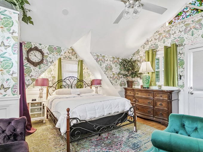 Botanical Bedroom Decor: Floral wallpaper dances with morning light in this charming room where you might wake to unexplained whispers instead of an alarm clock.
