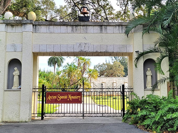 The Ancient Spanish Monastery's front gate welcomes visitors with statues of saints, standing as silent guardians to this transplanted medieval treasure.
