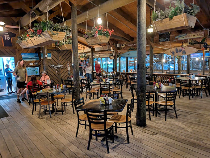 Rustic wooden beams and hanging planters create an island vibe that makes flip-flops feel like formal wear.