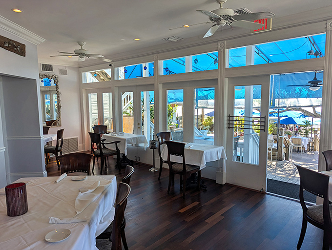 Sunlight streams through floor-to-ceiling windows, turning an ordinary lunch into a postcard moment. This is dining room real estate that would make Manhattan weep.