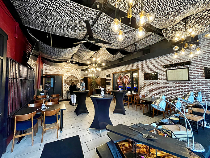 Geometric patterns dance across the ceiling while exposed brick walls whisper tales of the past &ndash; dining here is atmospheric imprisonment at its finest.