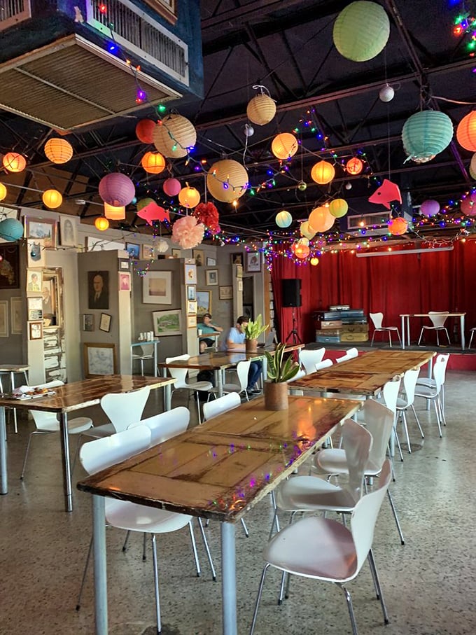 Step inside and be greeted by a ceiling dancing with colorful lanterns, rustic tables, and the promise of conversations worth remembering.