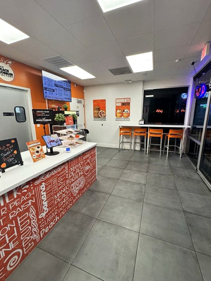 Inside, the clean, bright interior with pops of orange creates the perfect backdrop for serious dessert decisions.