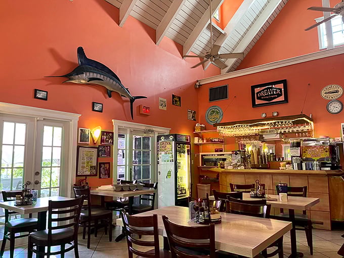 Coral walls soar to white-beamed ceilings where mounted marlins swim eternally above diners enjoying the perfect blend of spaciousness and intimacy.