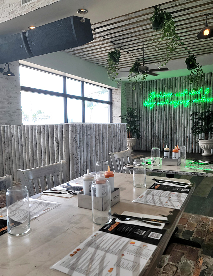Hanging plants and whitewashed wood panels bring a touch of tropical calm to balance the restaurant's edgy vibe.