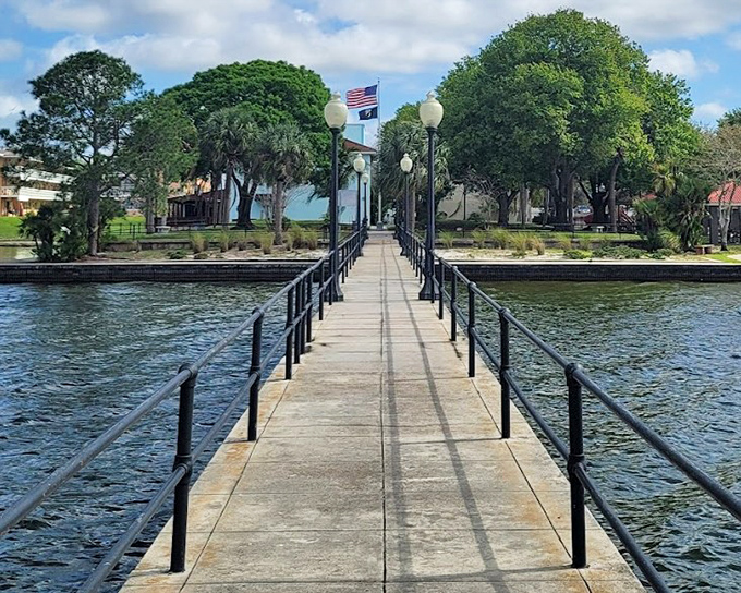 The Lake Jackson fishing pier stretches into the water like a wooden highway to nowhere, offering anglers prime real estate for catching dinner or at least some good stories.