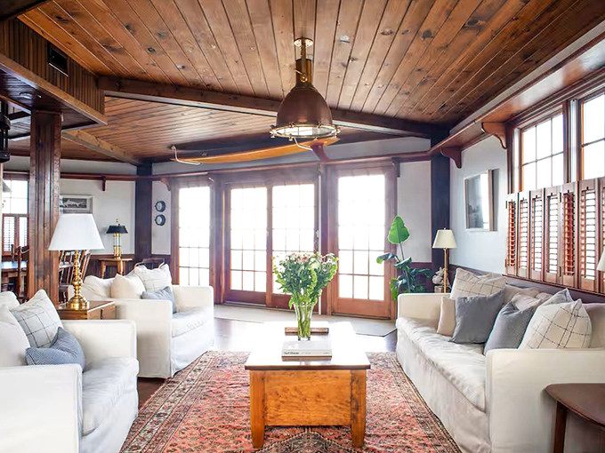 Sunlight floods the living room through expansive windows, where plush sofas invite lazy afternoon naps after morning beach walks.