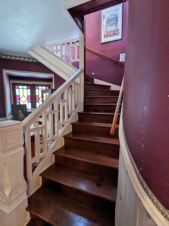 These stairs have witnessed generations of footsteps, both living and perhaps otherwise, connecting the home's mysterious past to its present.