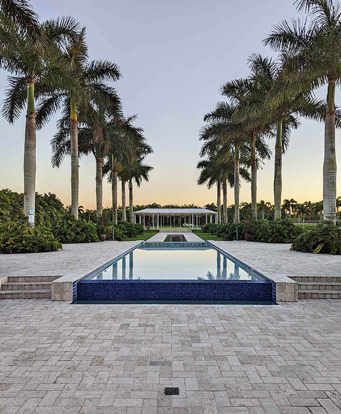 Symmetry and serenity meet in this picture-perfect pool avenue, where royal palms stand at attention like nature's own honor guard.