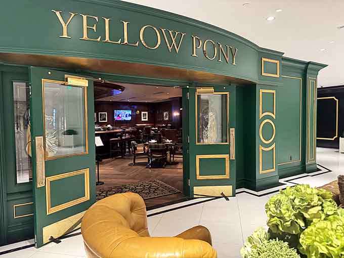 The Yellow Pony entrance beckons with emerald elegance, promising craft cocktails and comfort food that'll make you forget your diet ever existed.
