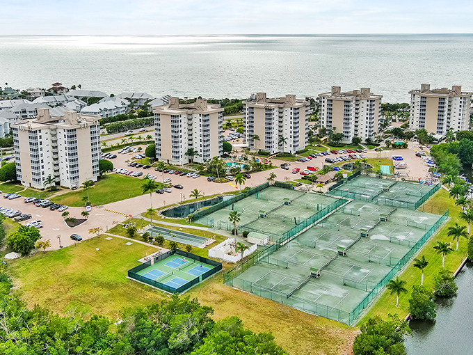 Waterfront condos stand like sentinels guarding tennis courts and the glistening Gulf beyond &ndash; Florida living defined.