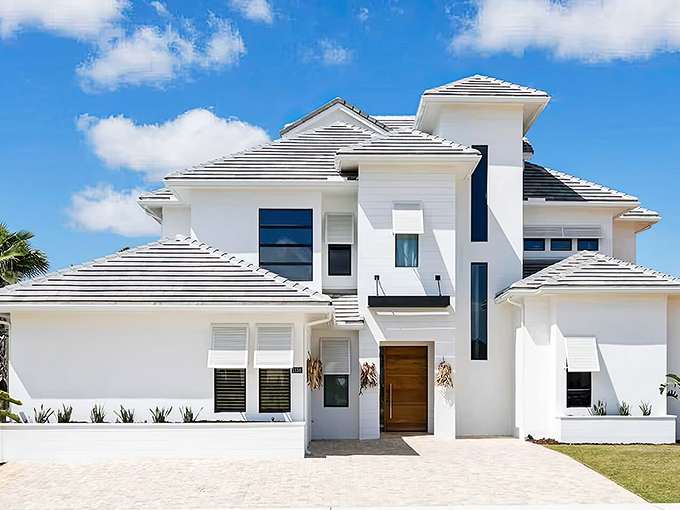 Modern elegance meets Florida sunshine in this striking white exterior that gives no hint of the playful wonders within.